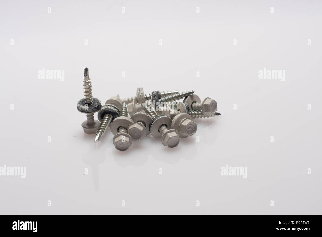neatly arranged screws in a row Stock Photo - Alamy