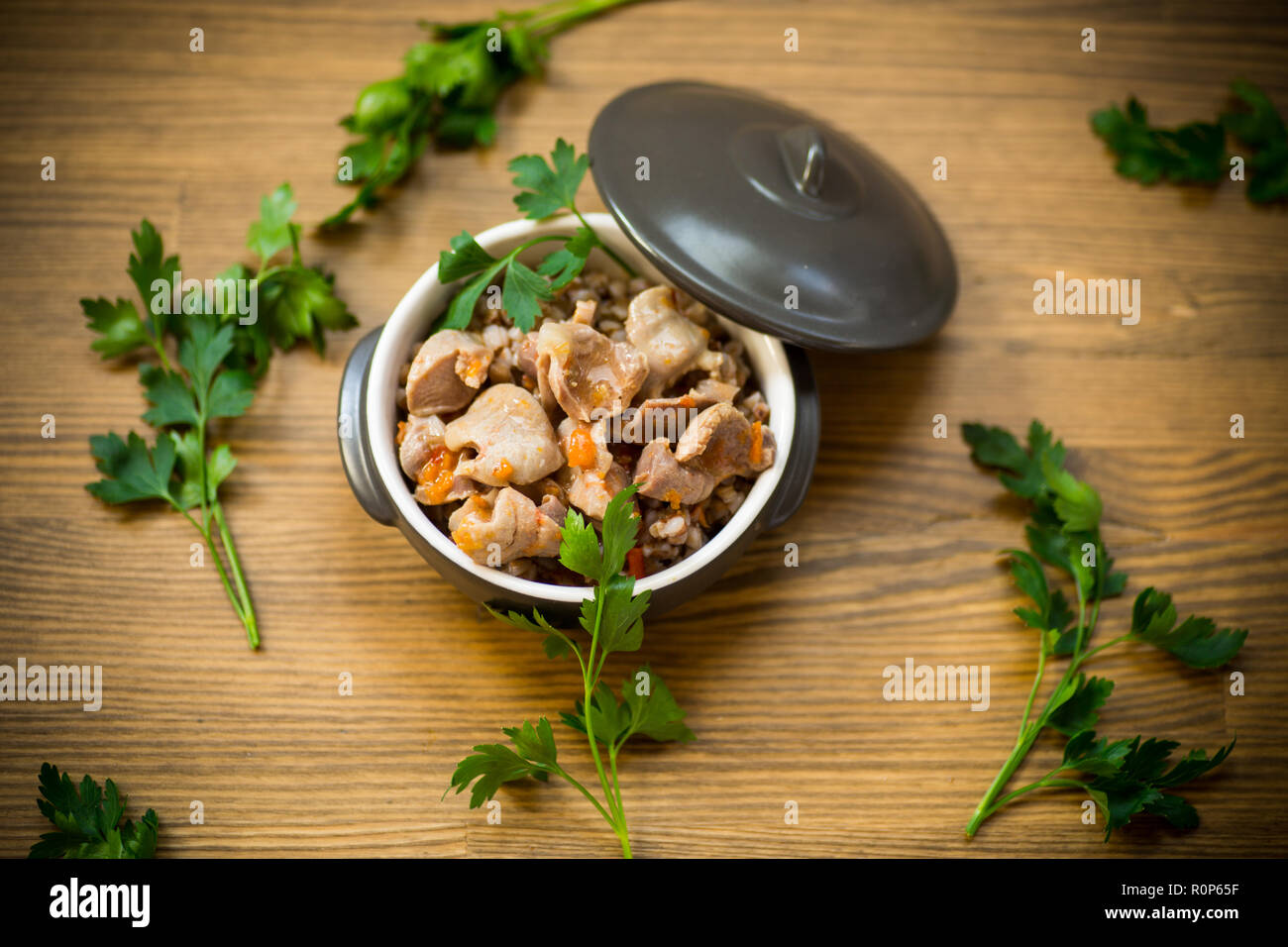 stewed chicken stomachs with vegetables and buckwheat in a bowl on a ...