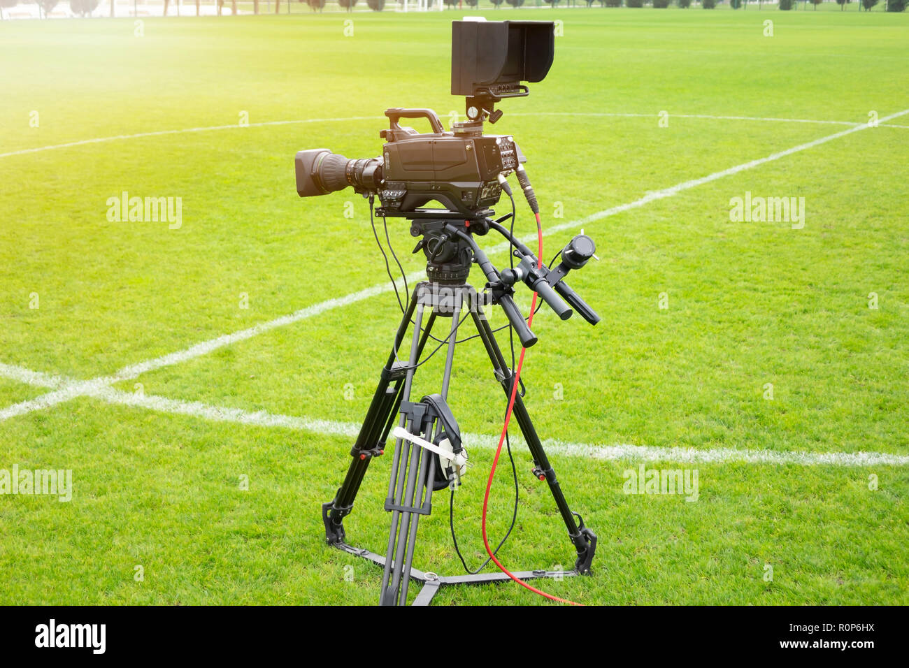 TV camera at the stadium, broadcasting during a football (soccer) match ...