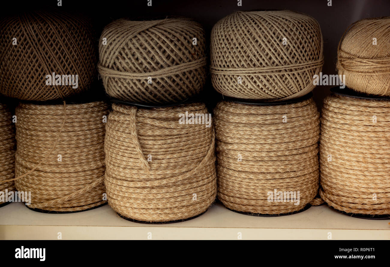 Plenty of spools or rolls of brown color linen string Stock Photo - Alamy