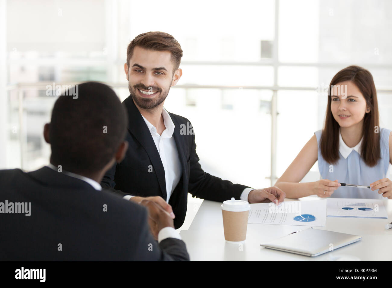 Multiethnic colleagues handshake getting acquainted at meeting Stock ...