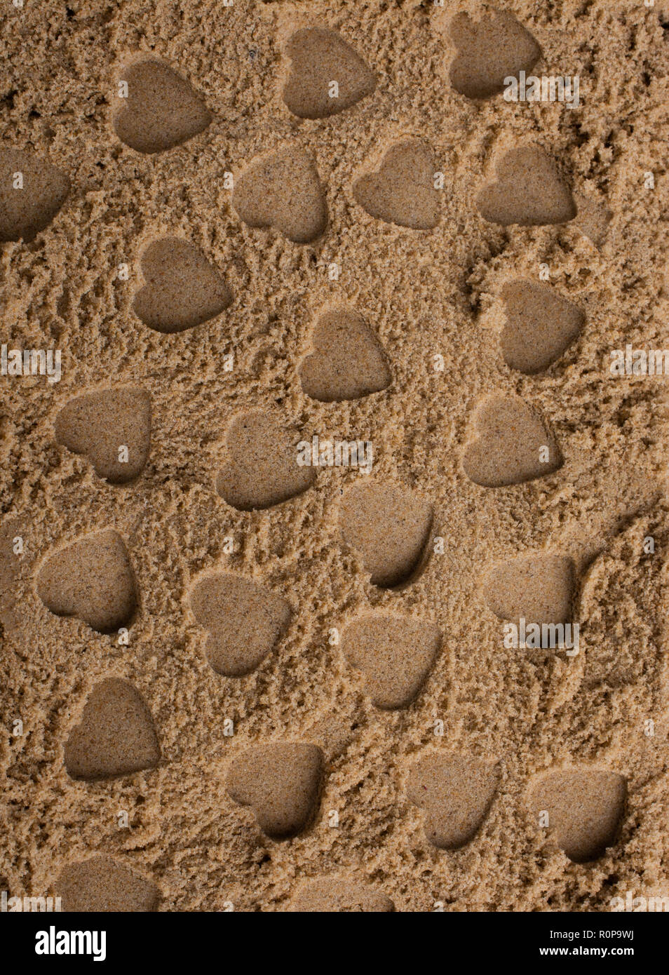 Heart shapes made on the sand background in view Stock Photo - Alamy