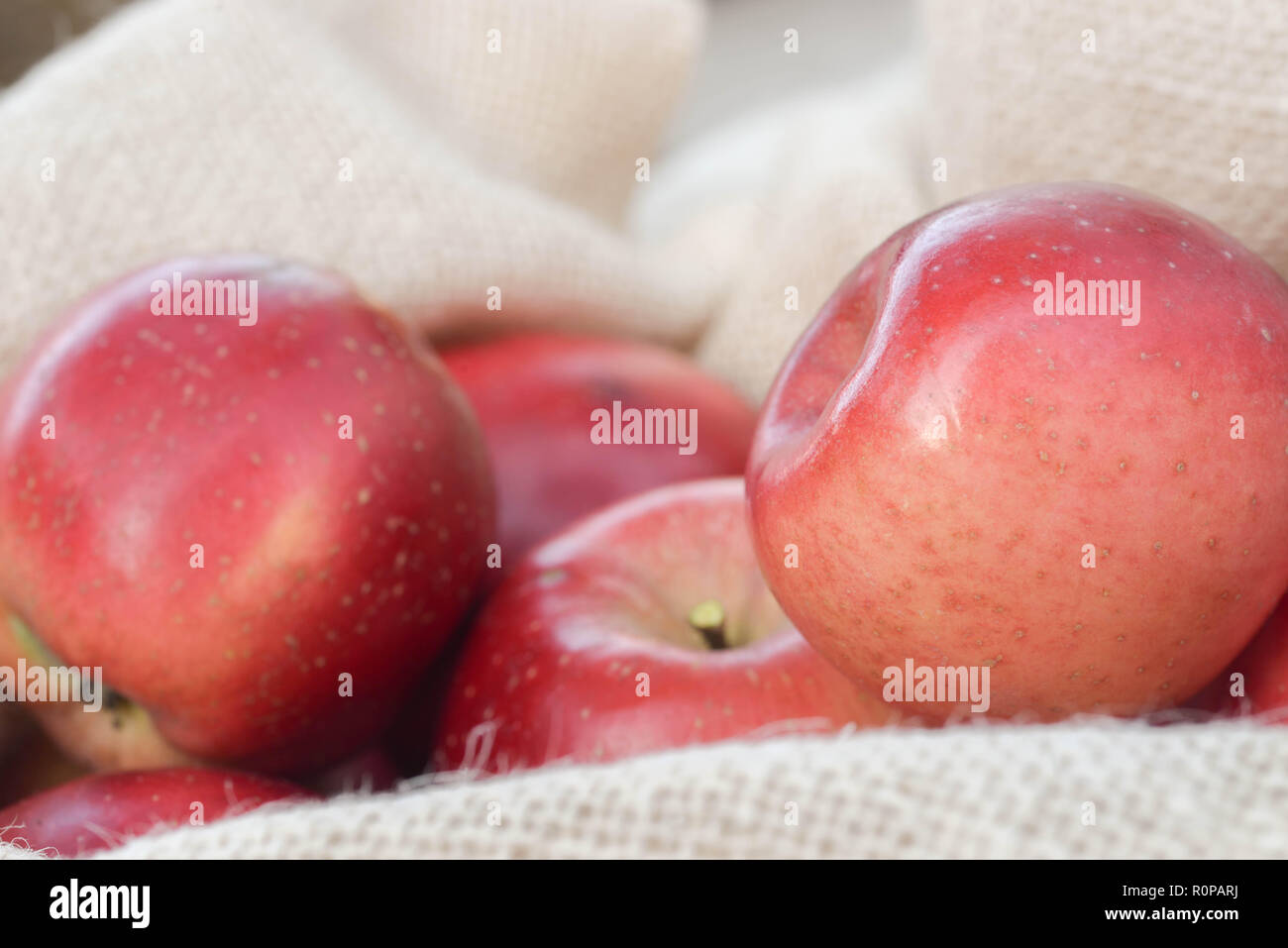 group of red apples on jute textile background Stock Photo - Alamy