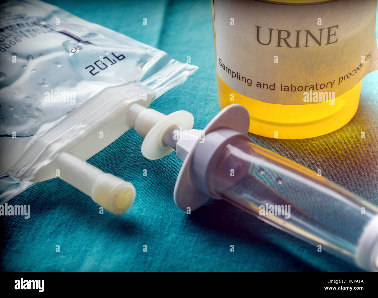 Dial flow next to a urine sample at a hospital table, conceptual image ...