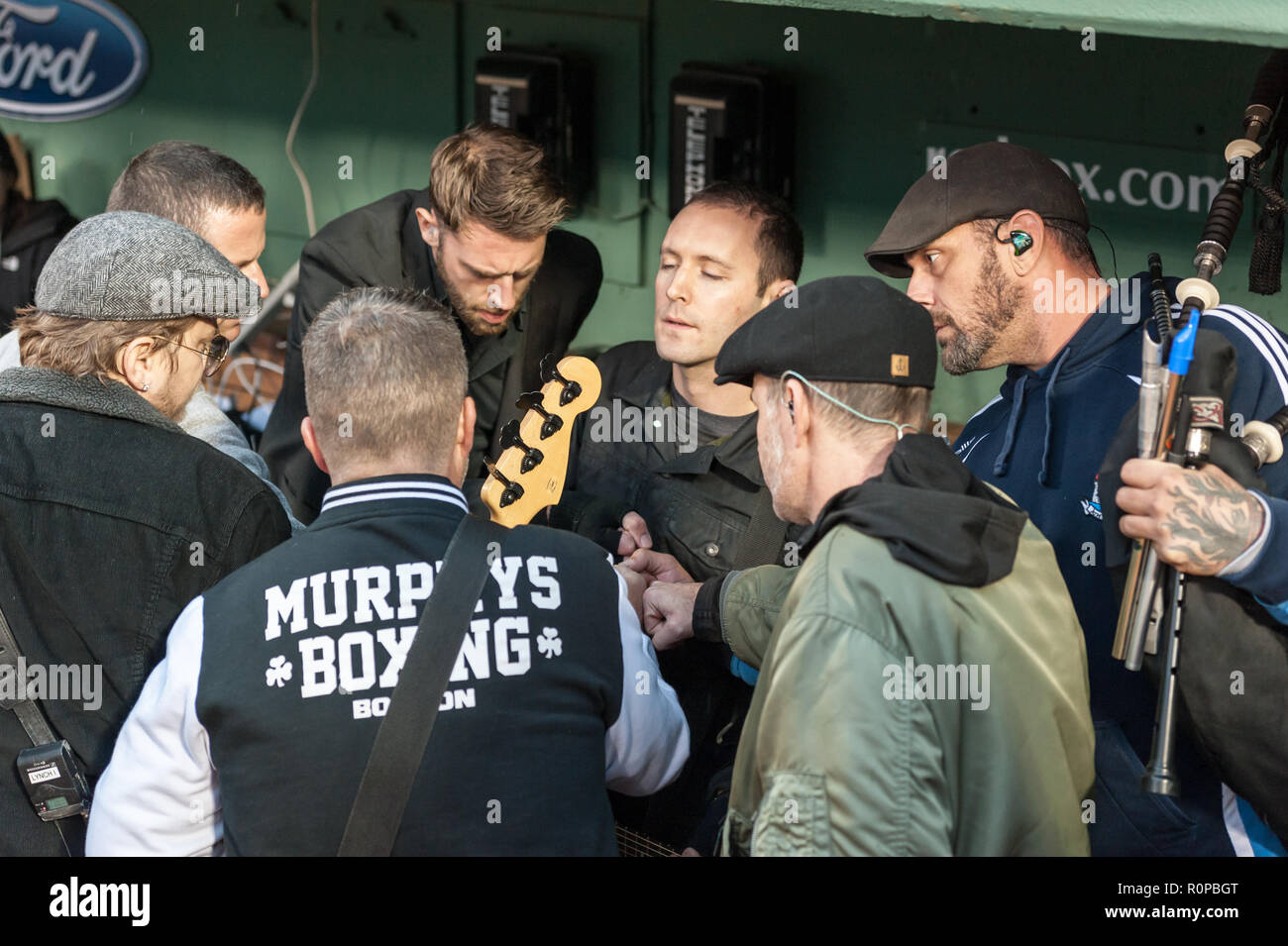 Band members of the Dropkick Murphys in the Red Sox dugout giving each ...