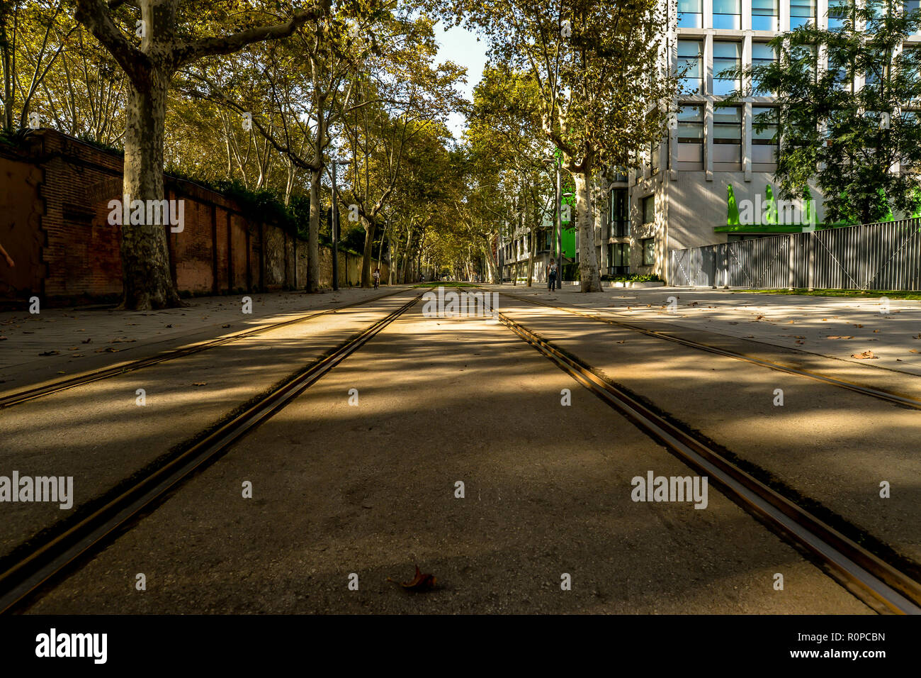Trams lines behind the park in Barcelona Stock Photo - Alamy