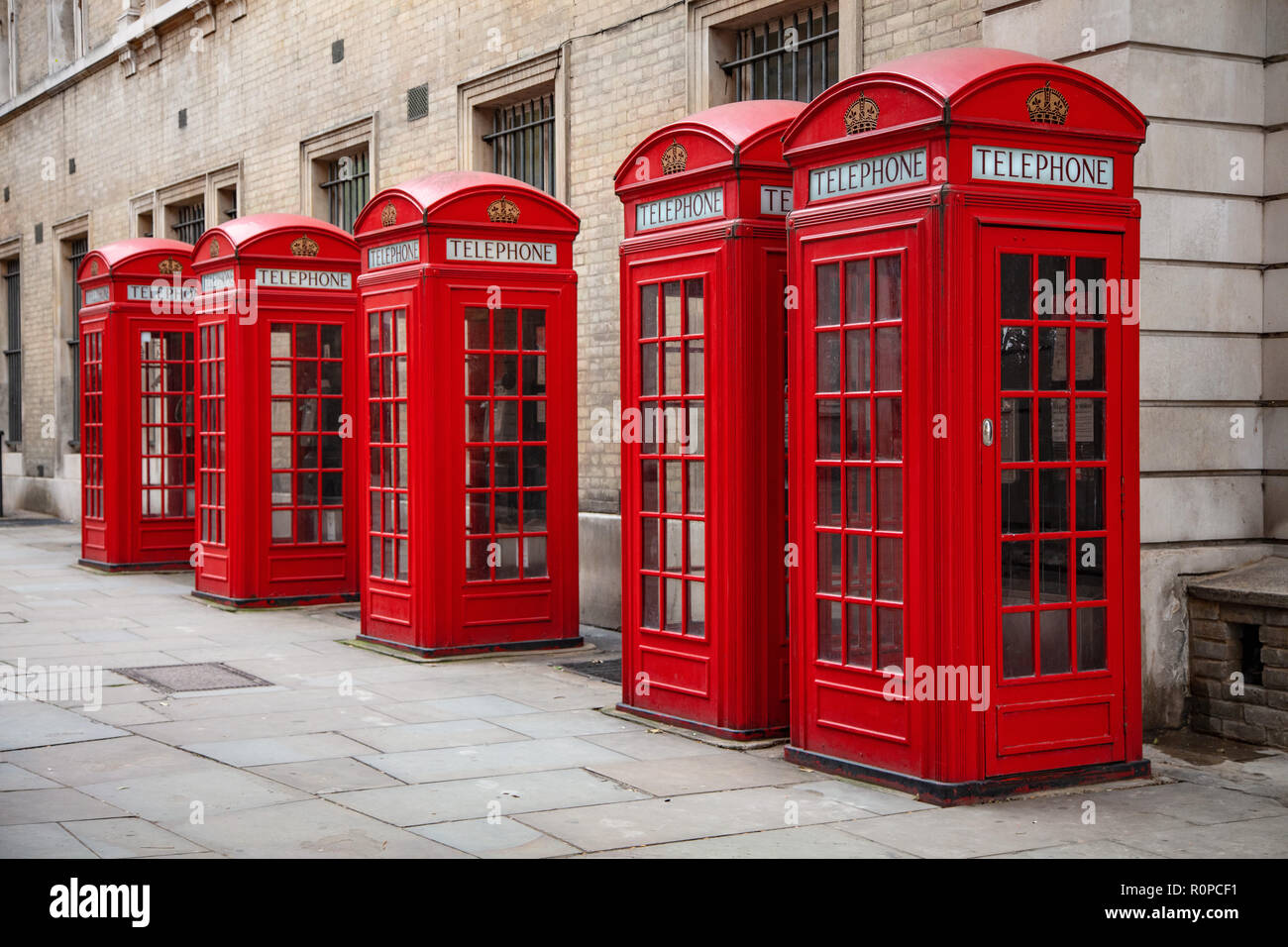 Row of five classic traditional red telephone boxes, London, England ...
