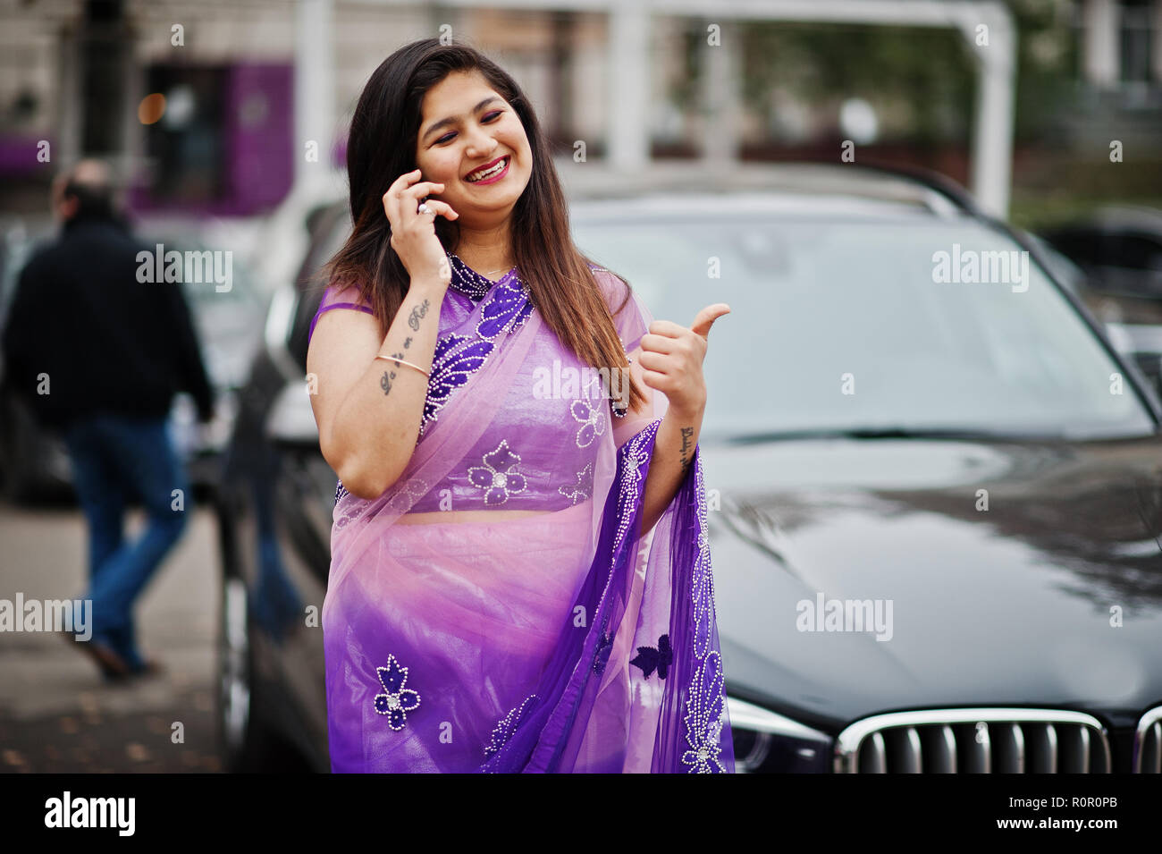 Indian hindu girl at traditional violet saree posed at street against ...