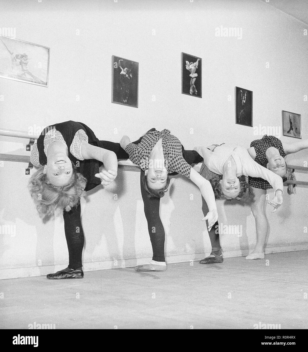 Ballet school in the 1940s. Three young dancers are practising their ...