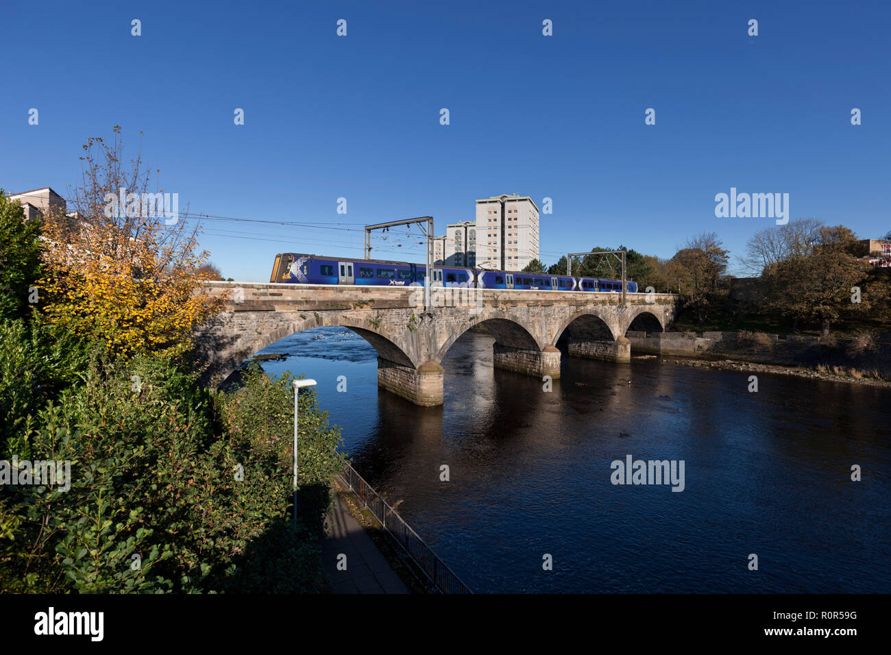 A Scotrail class 380 electric train departing Ayr crossing the viaduct ...
