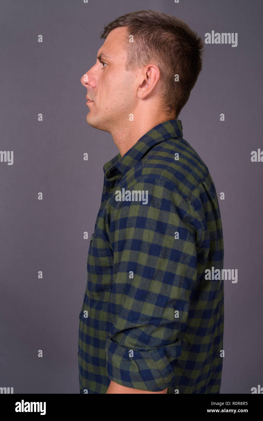 Handsome man with short hair against gray background Stock Photo - Alamy