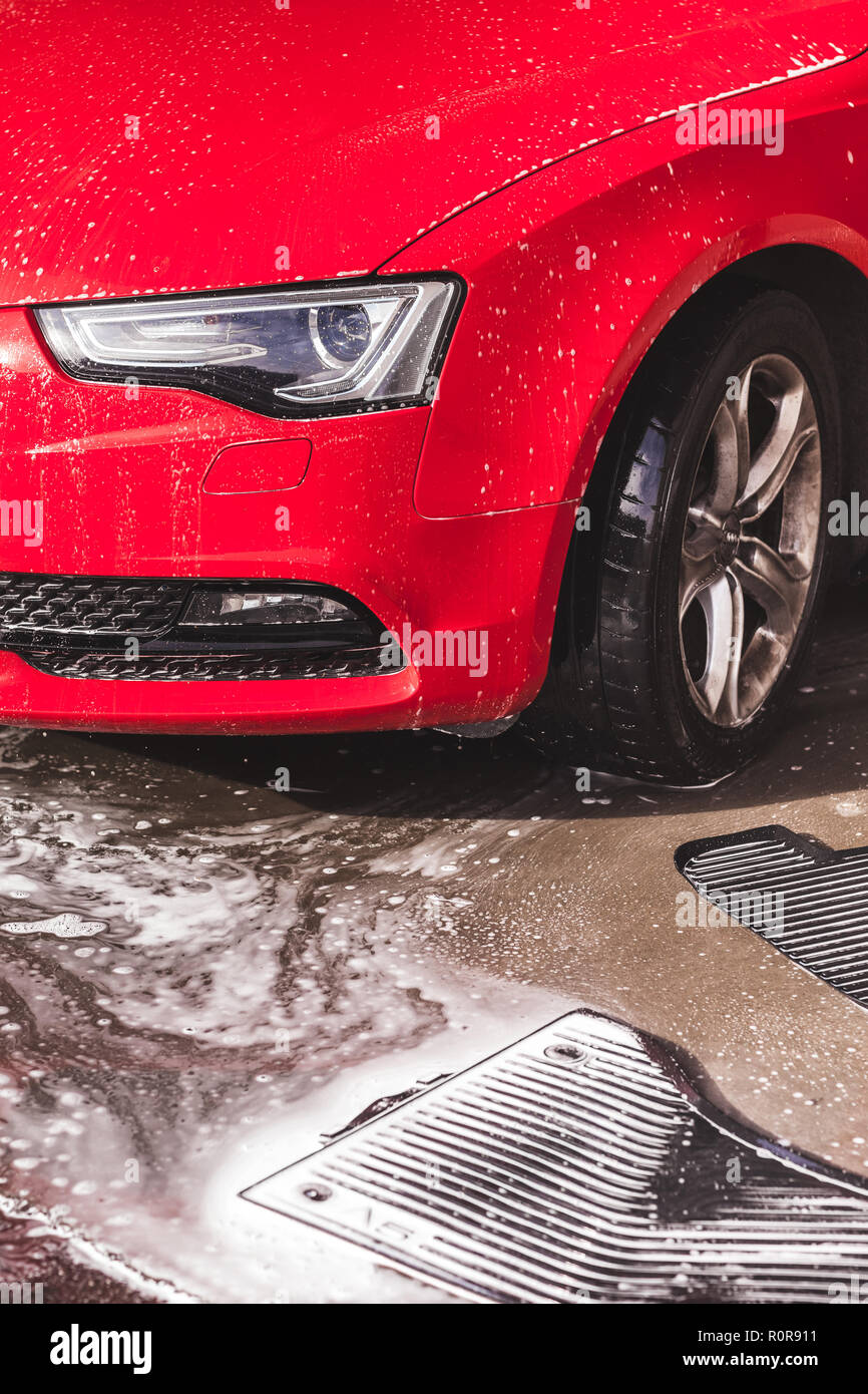 Washing red sport car Stock Photo - Alamy