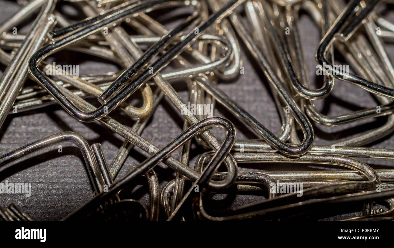 metallic triangular paper clip. office and school supply background ...