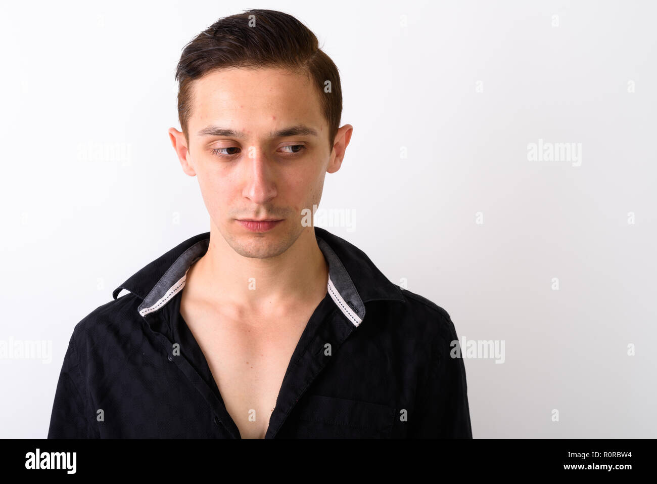 Close up of young handsome man thinking while looking down with Stock ...