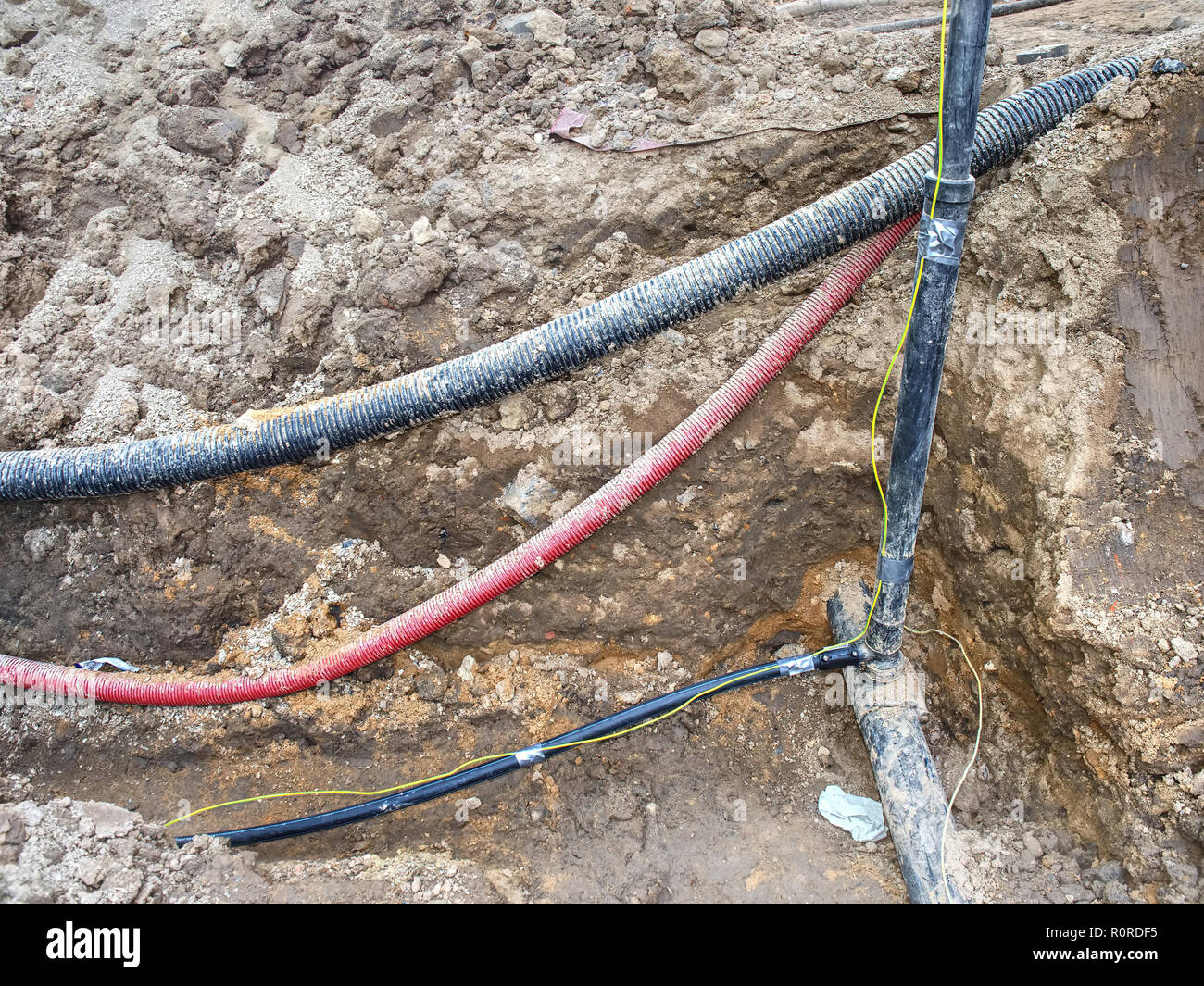 Crossection of metallic and fiber optic cables with potable water tap ...