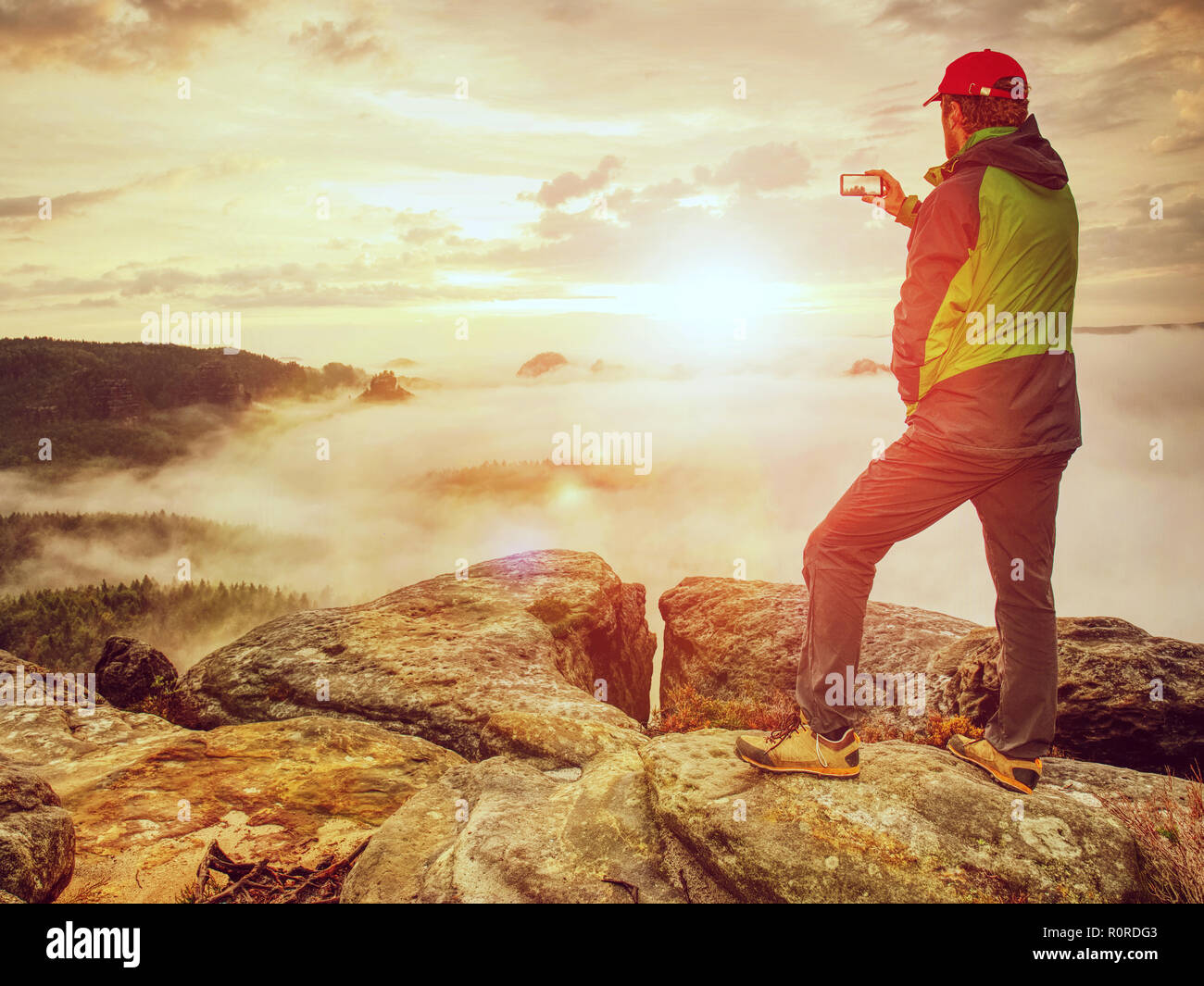 Tall man hiking in autumn nature. Tourist on the mountain taking photos ...