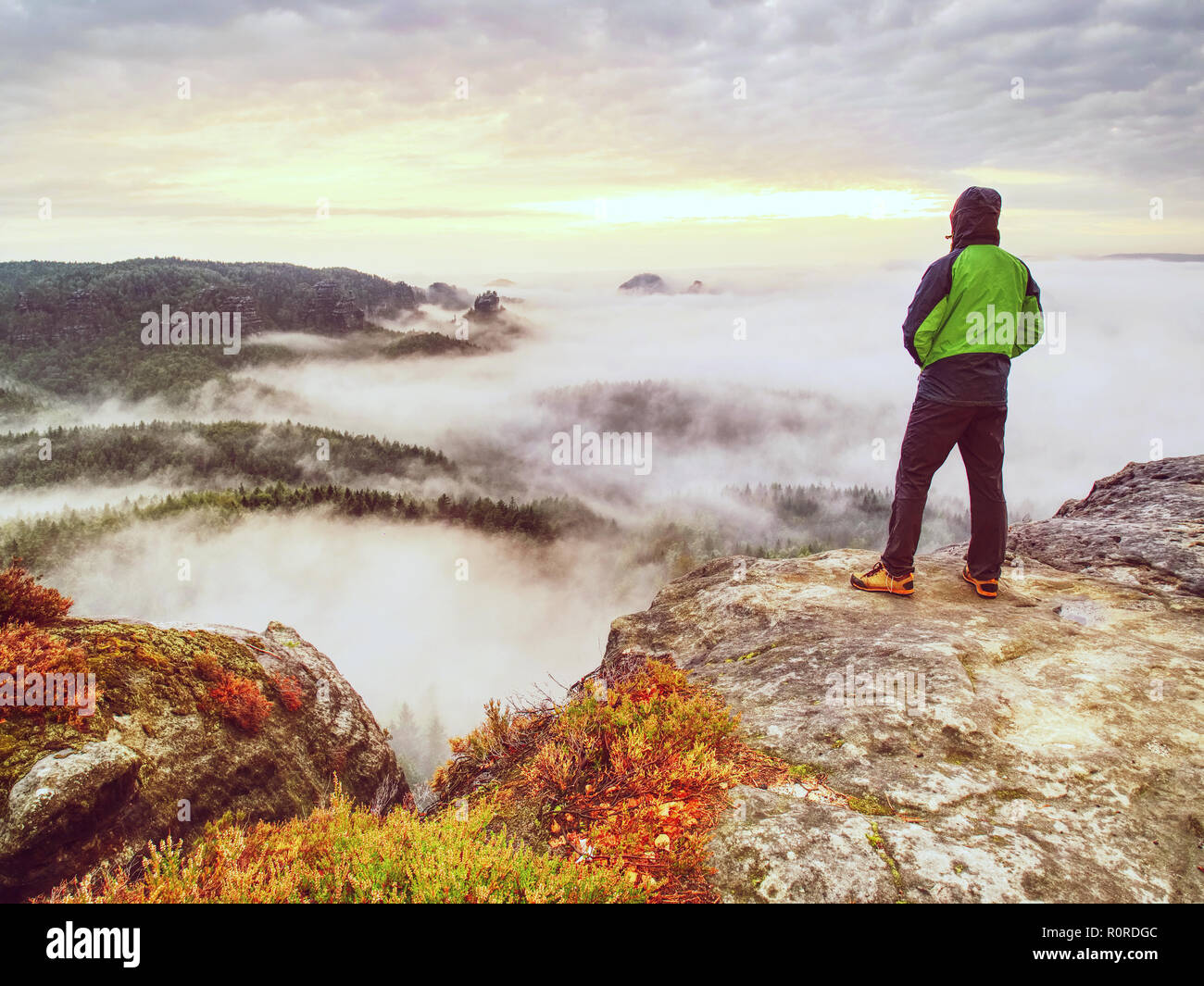 Tall guy with hands in pocket in blue shirt standing and watch the ...