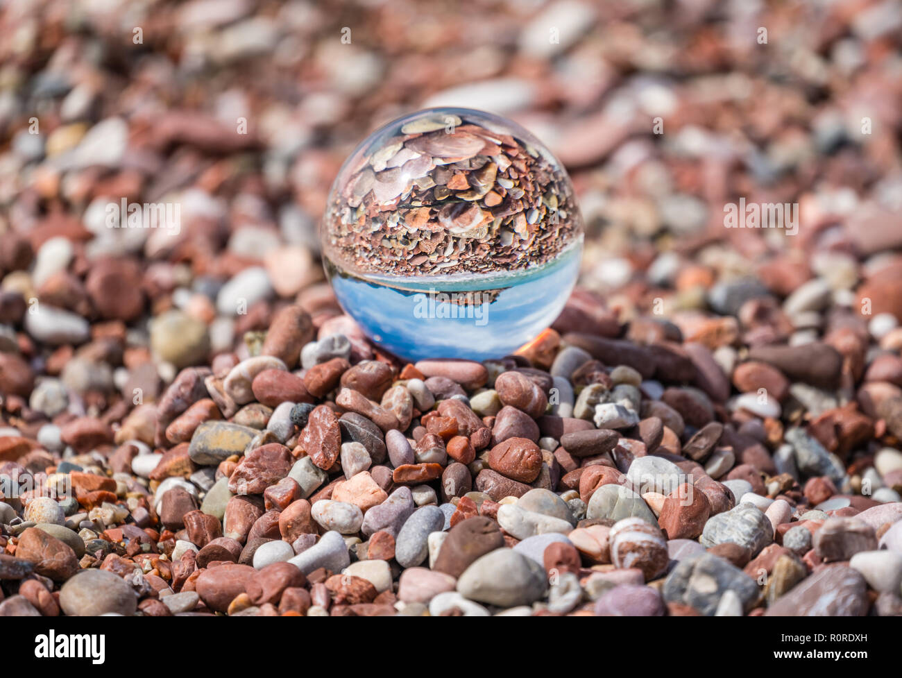 Historical Sveti Stefan old town reflected in large transparent glass ...
