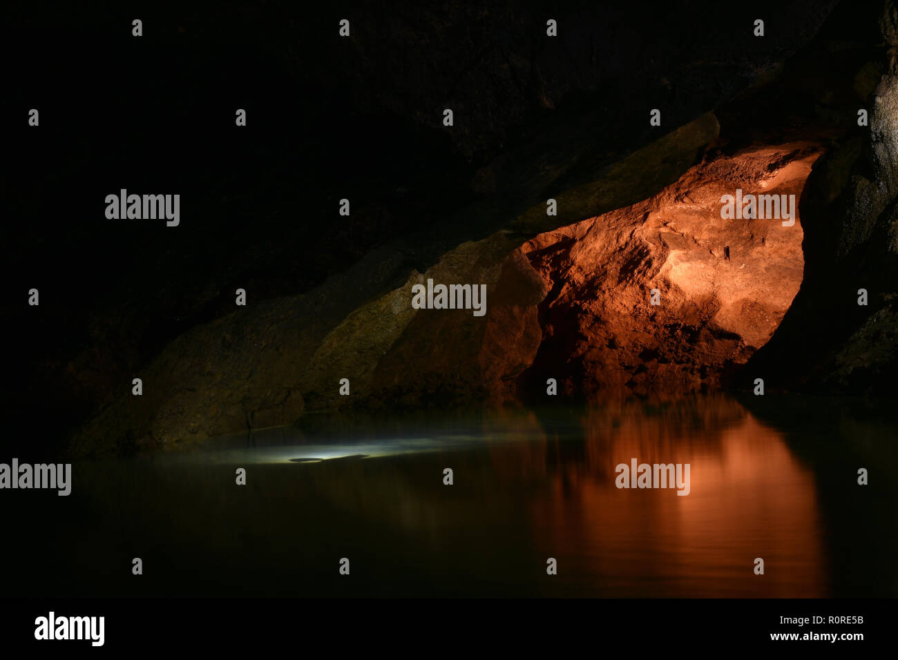 the vaults of the cave with an underwater lake with lighting, color ...