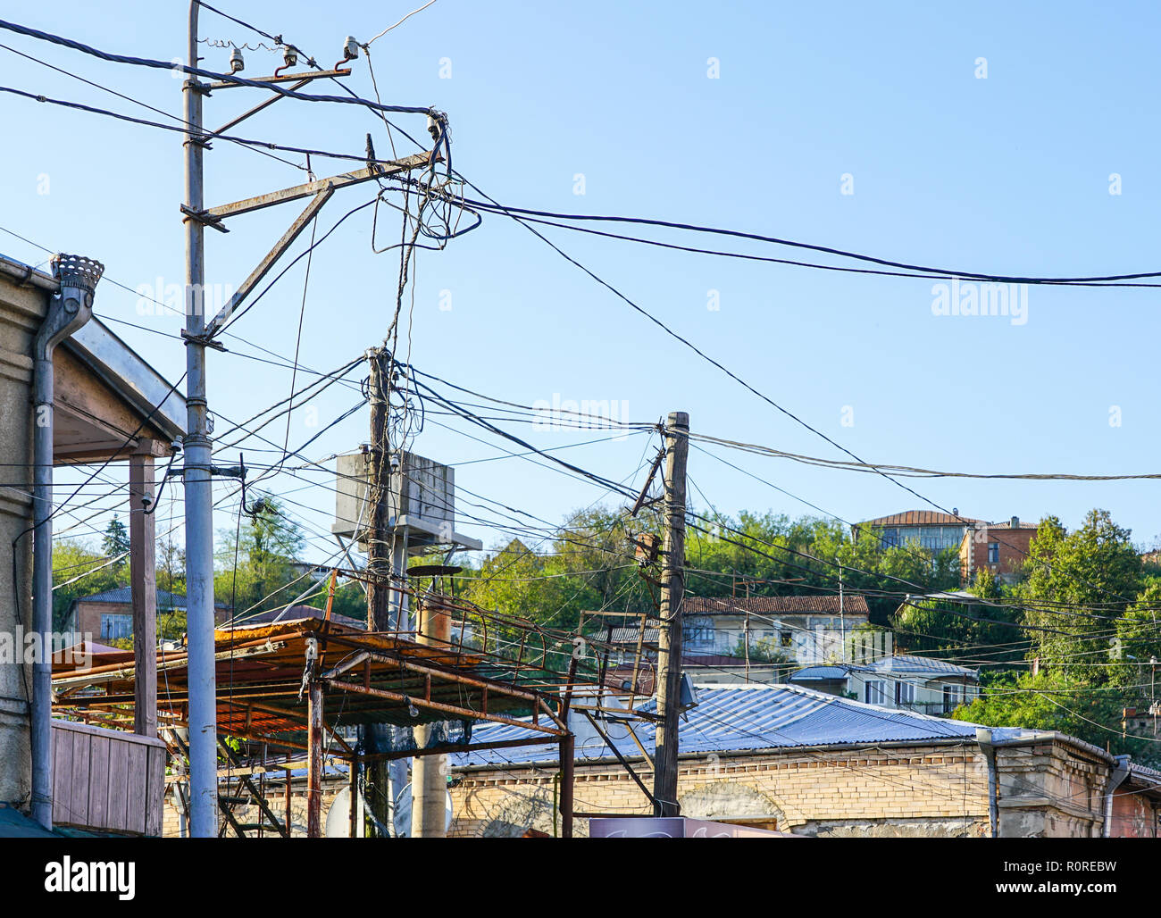 Old lighting post with many electric supply wires or cables for ...