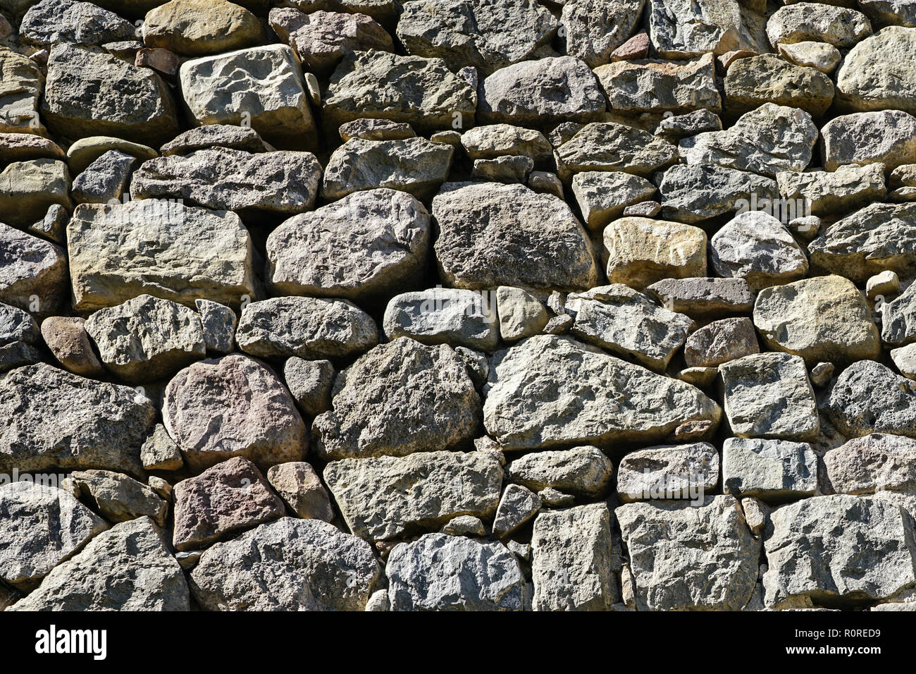 Stone wall background of historic ruins, composition of natural stones ...
