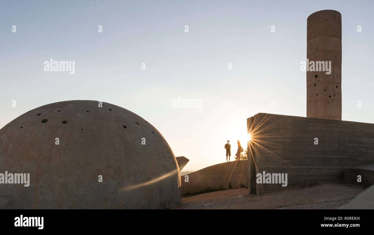 Two people standing at the concrete monument, Monument of the Negev ...