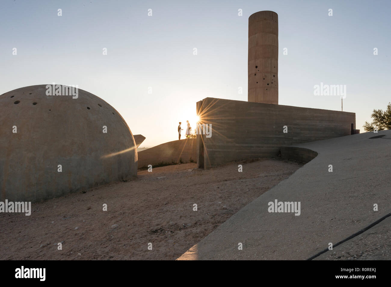Two people standing at the concrete monument, Monument of the Negev ...