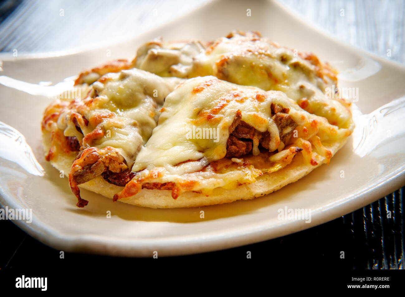 Colombian cuisine loaded grilled cheese arepas with bacon Stock Photo ...