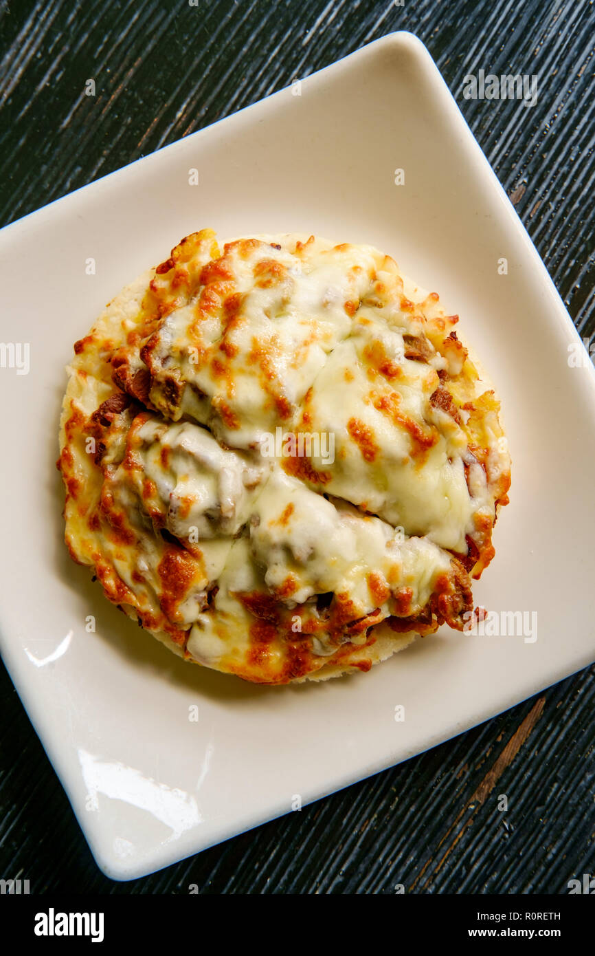 Colombian cuisine loaded grilled cheese arepas with bacon Stock Photo ...