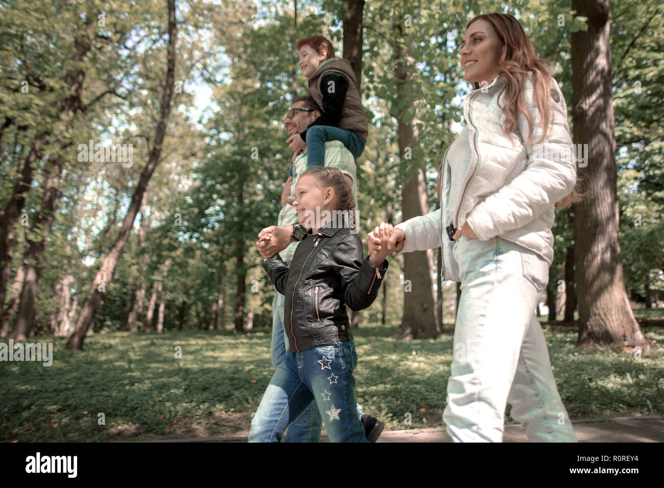 family on a walk in the Park on Sunday Stock Photo - Alamy