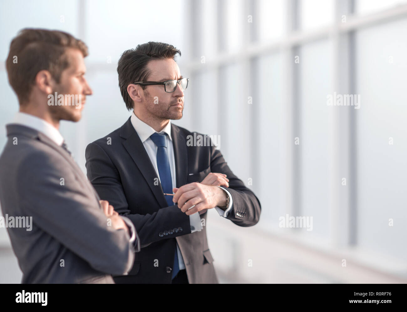 business partners talking near the office window Stock Photo - Alamy