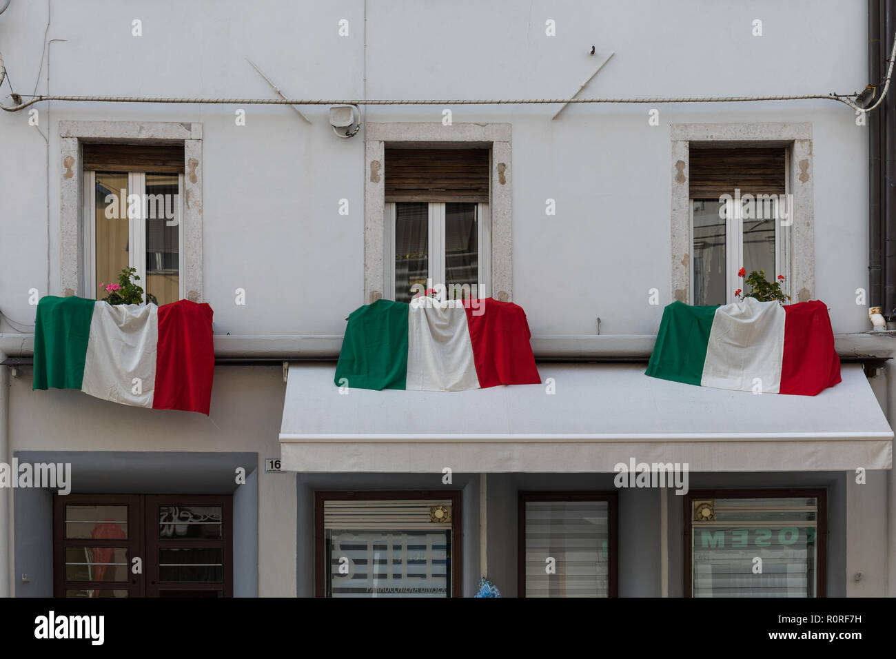 Italian national flags hanging from windows Stock Photo - Alamy