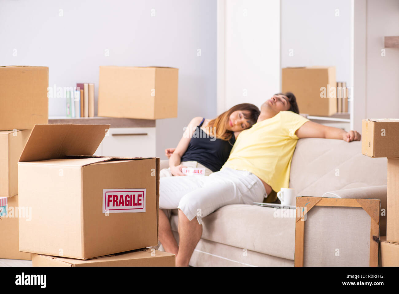 Young couple moving to new flat with fragile things Stock Photo - Alamy