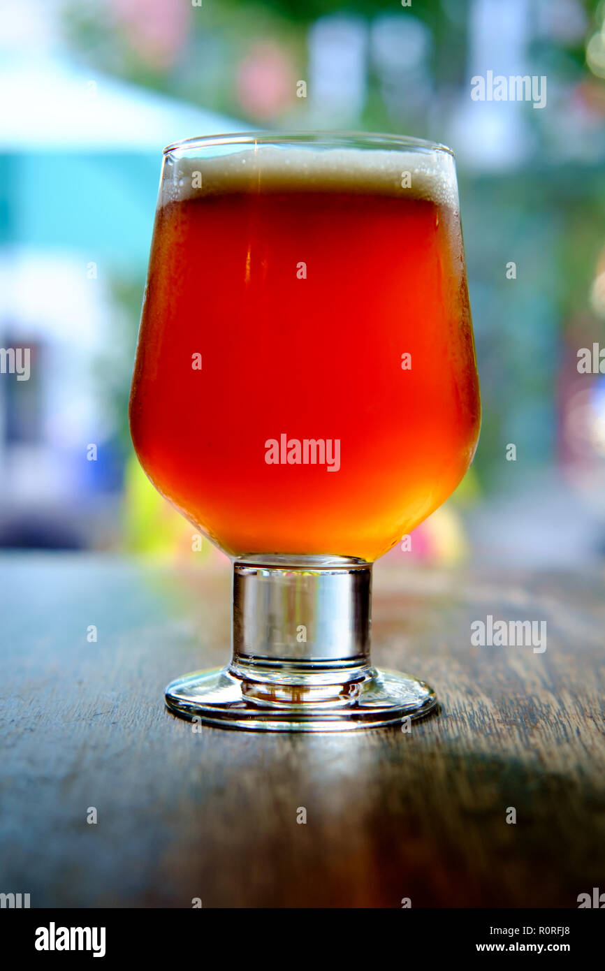 Foamy glass of cold beer amber color with lots of hops Stock Photo - Alamy