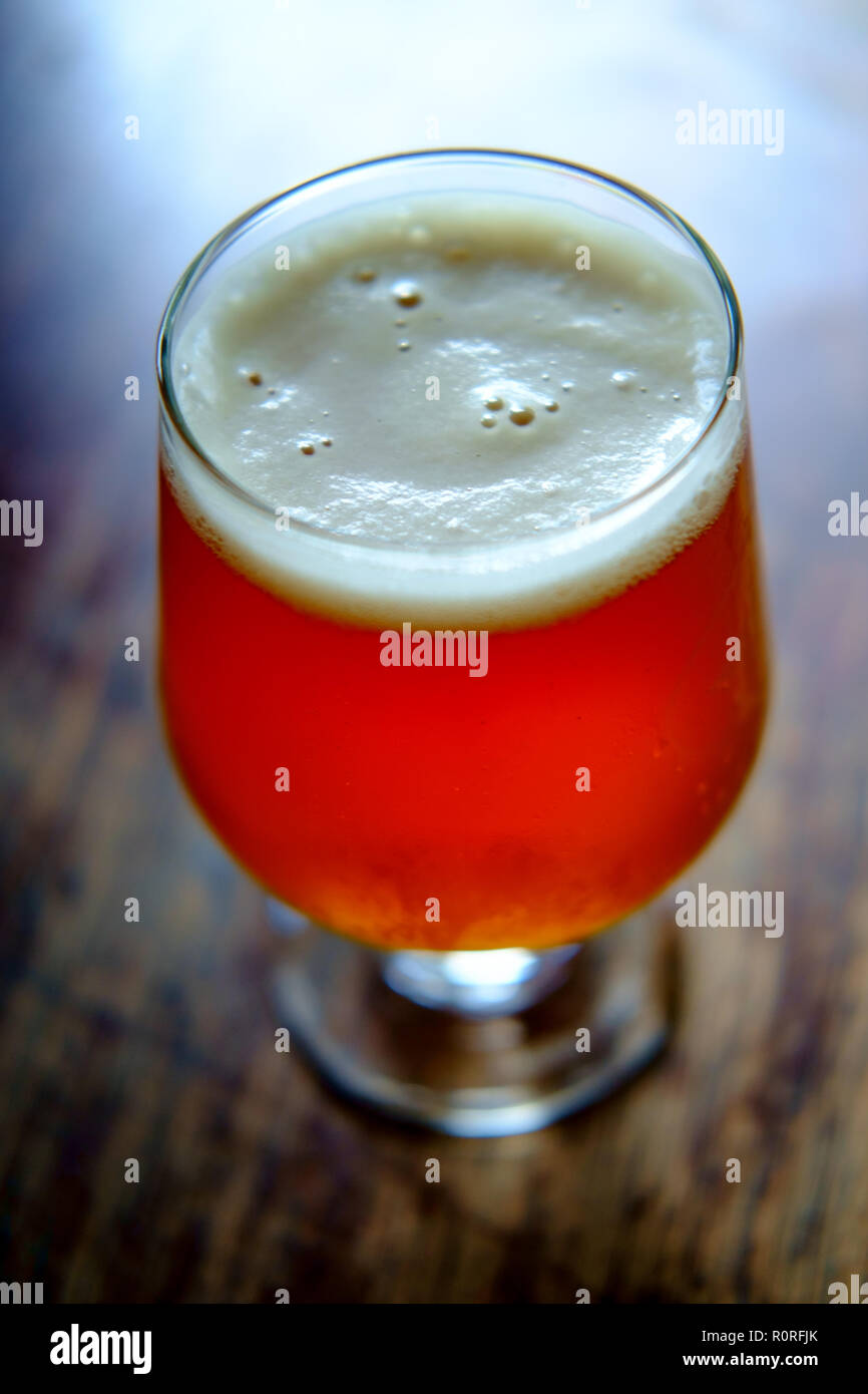 Foamy glass of cold beer amber color with lots of hops Stock Photo - Alamy