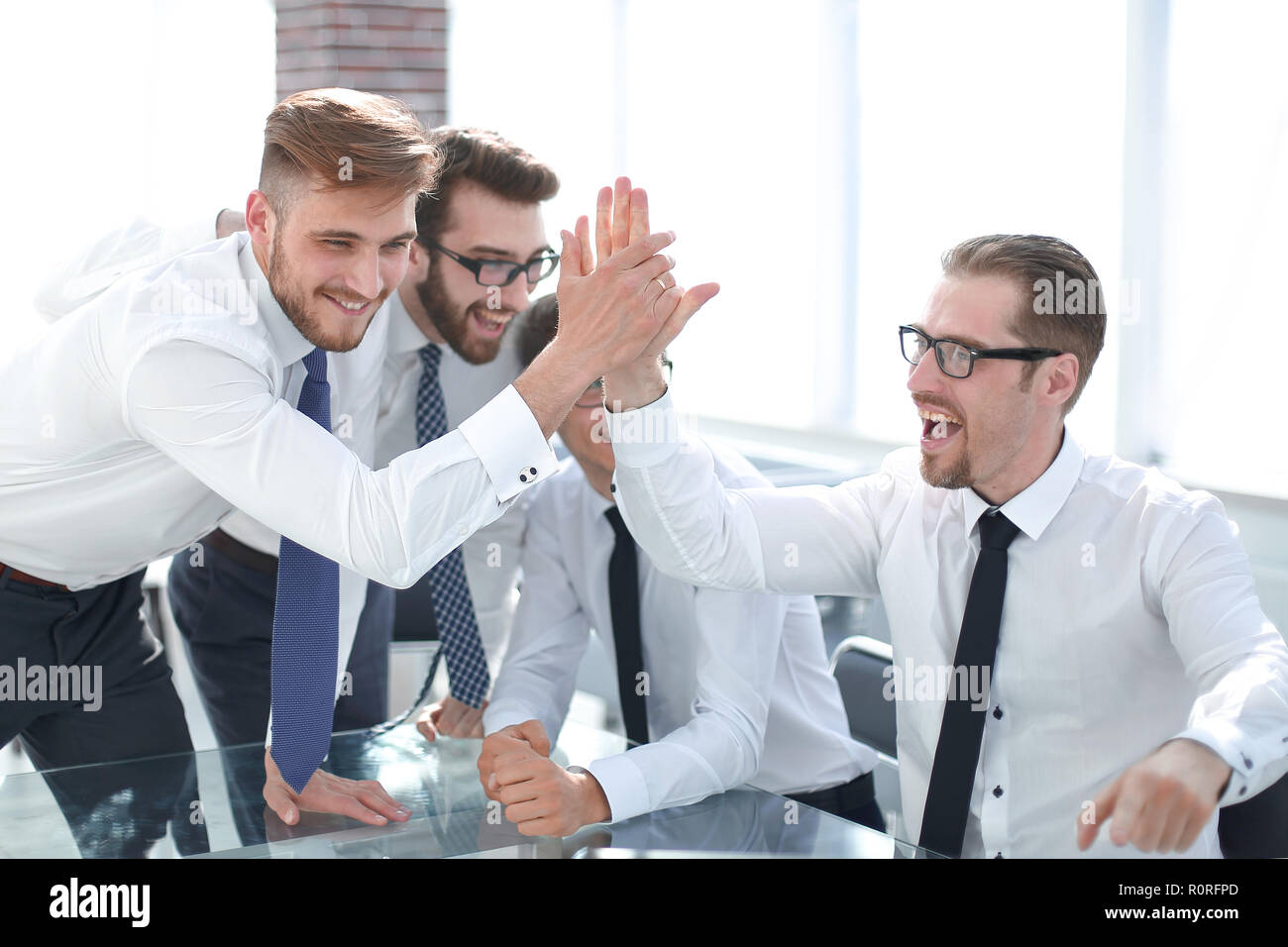 employees giving each other a high five Stock Photo - Alamy