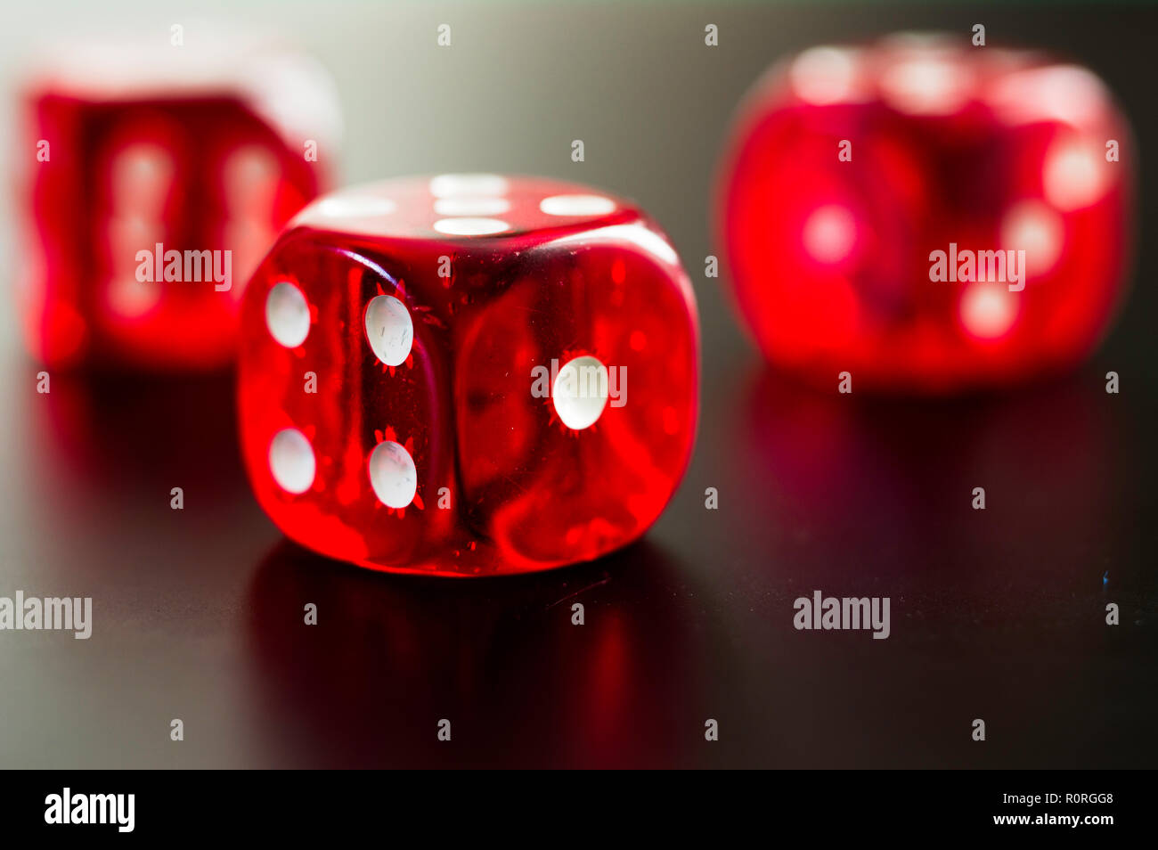 detail of three red dice on black background Stock Photo - Alamy