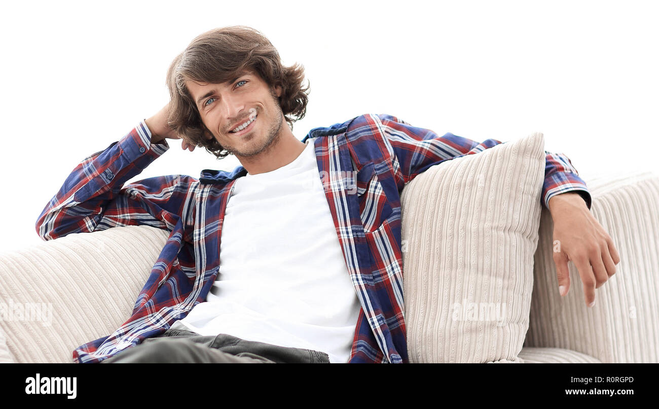 serious modern guy sitting on the couch Stock Photo - Alamy