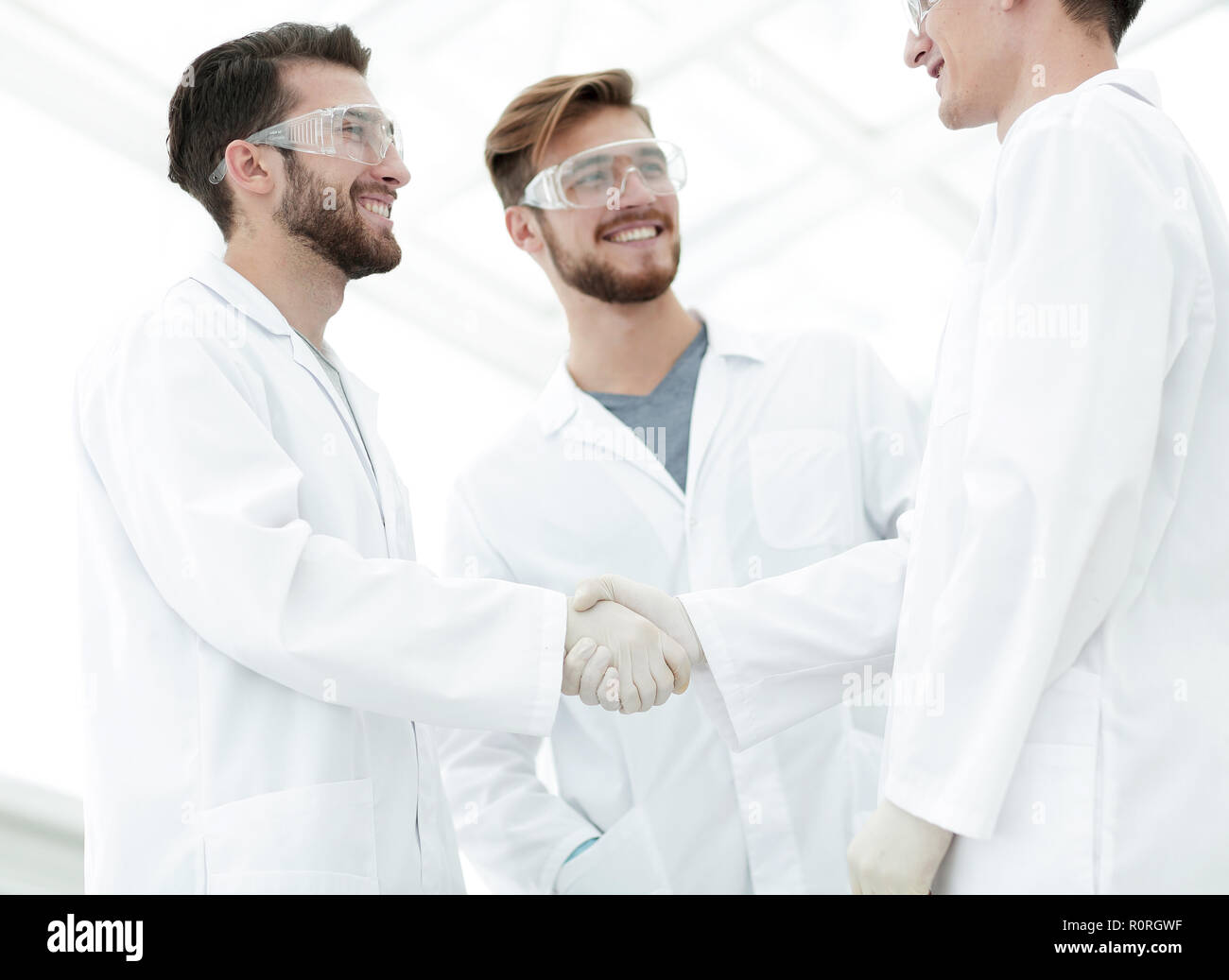 blurred image of a handshake between scientists Stock Photo - Alamy