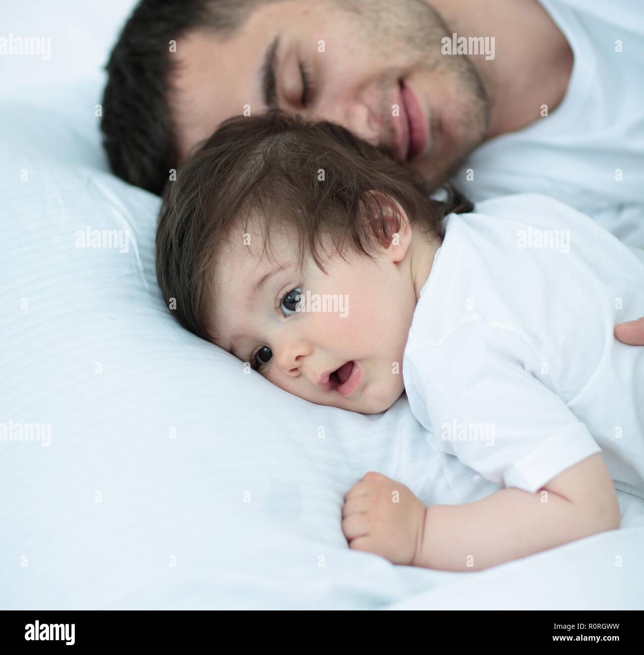 father and baby sleeping peacefully in bed Stock Photo - Alamy