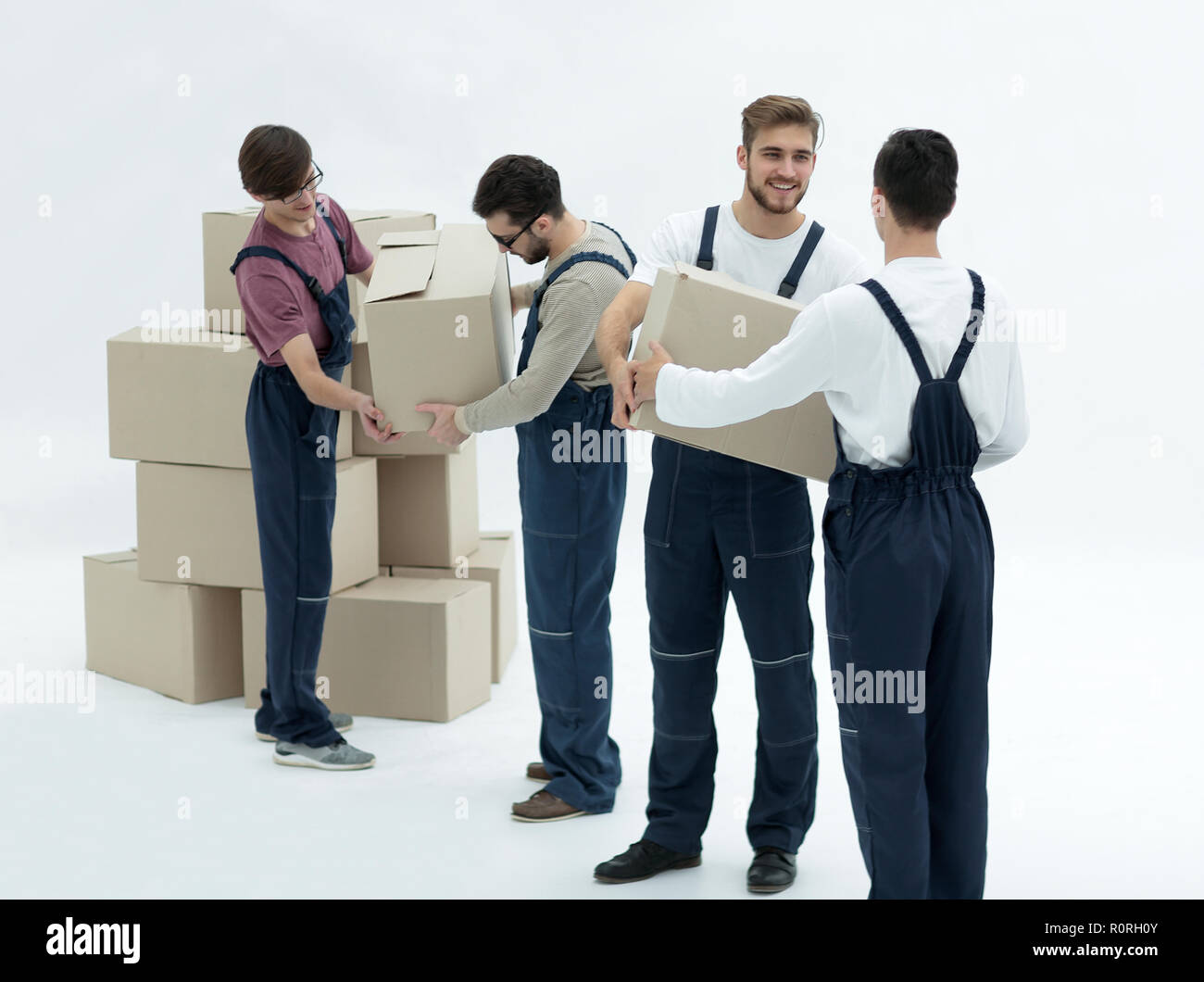 Movers lifting stack of cardboard moving boxes isolated on white Stock ...