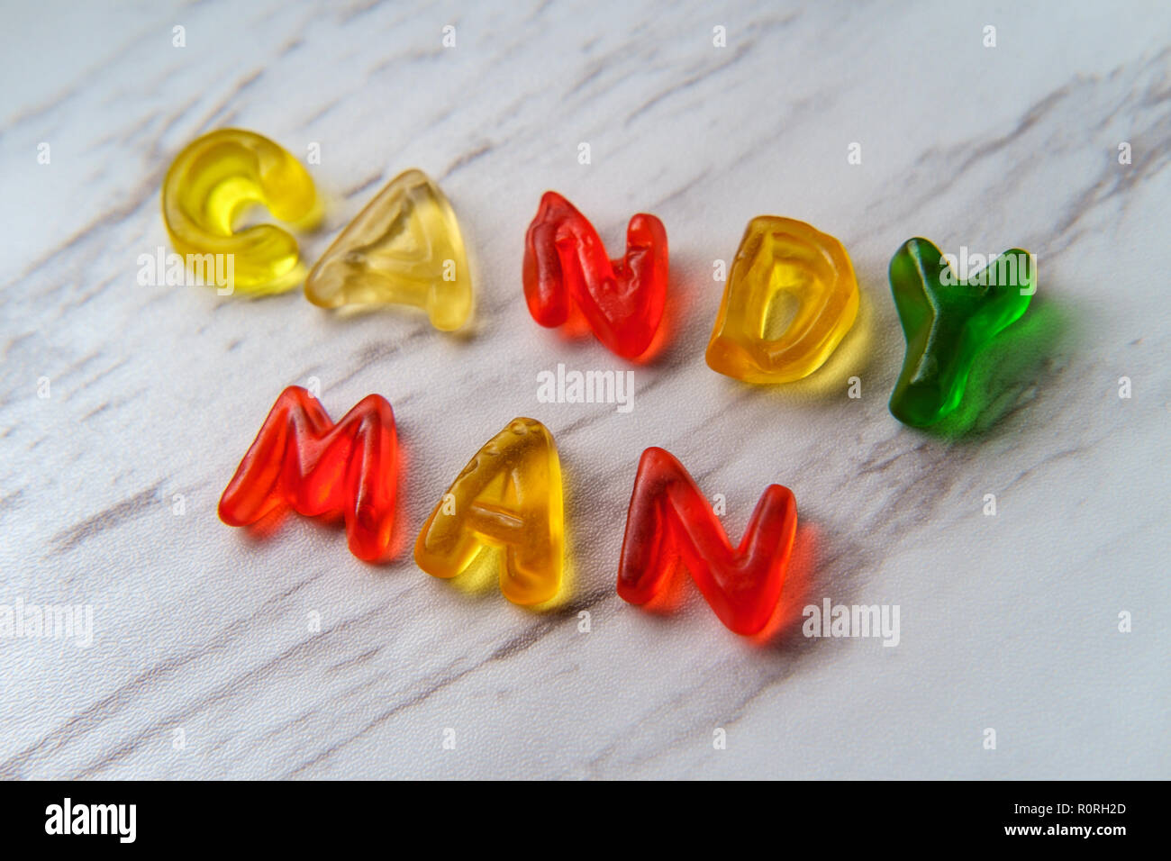 Assorted colorful gummy candy letters spell the words Candy Man Stock ...