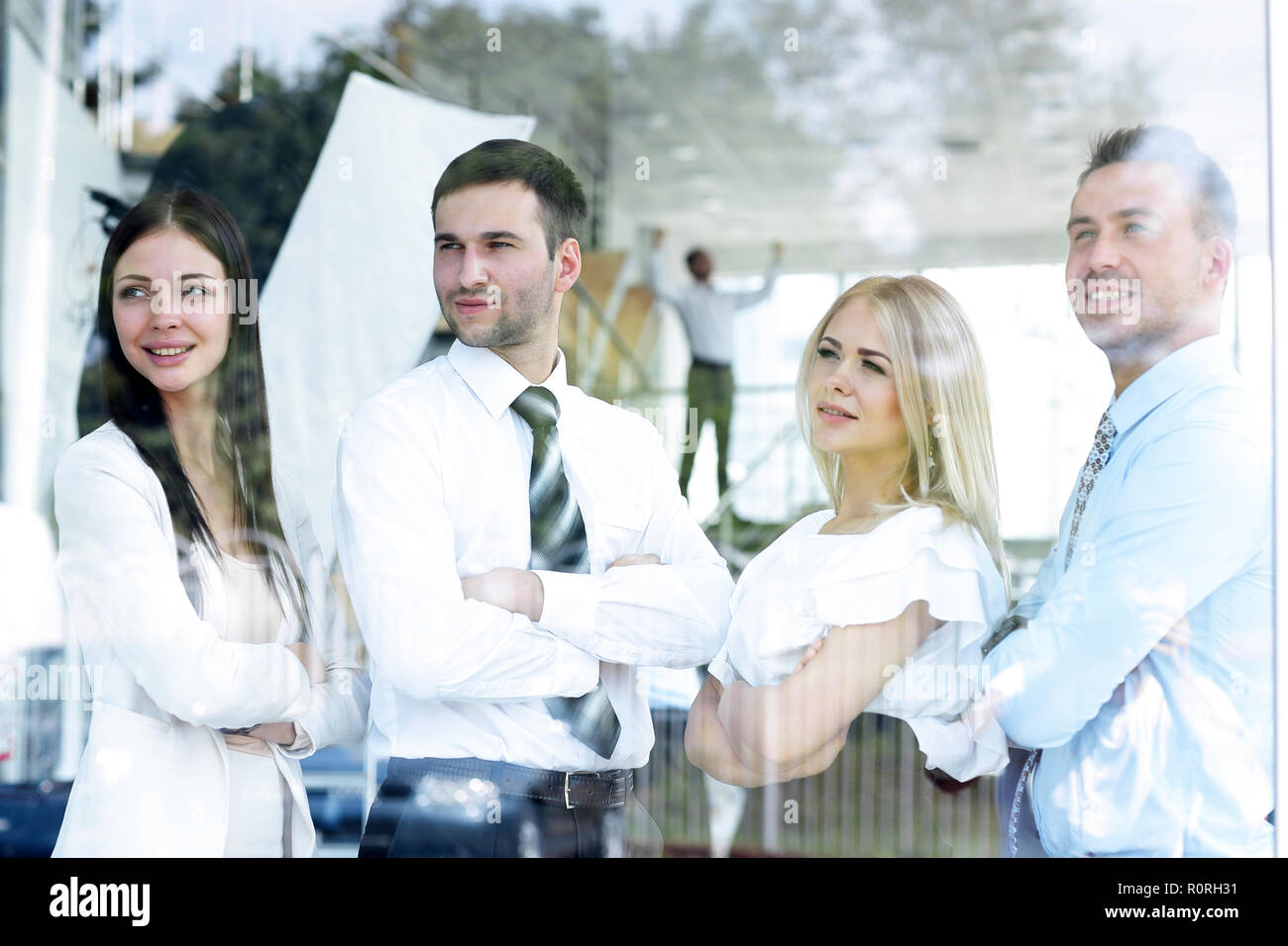 view from behind glass.confident business people looking out the office ...