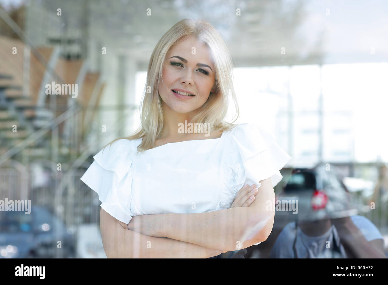 smiling business woman looking out the window Stock Photo - Alamy