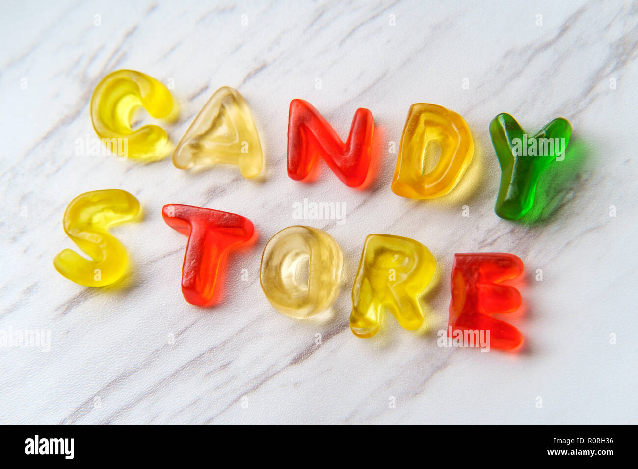 Assorted colorful gummy candy letters spell the words Candy Store Stock ...