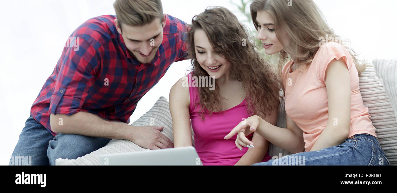 group of students sitting on the sofa in the living room Stock Photo ...