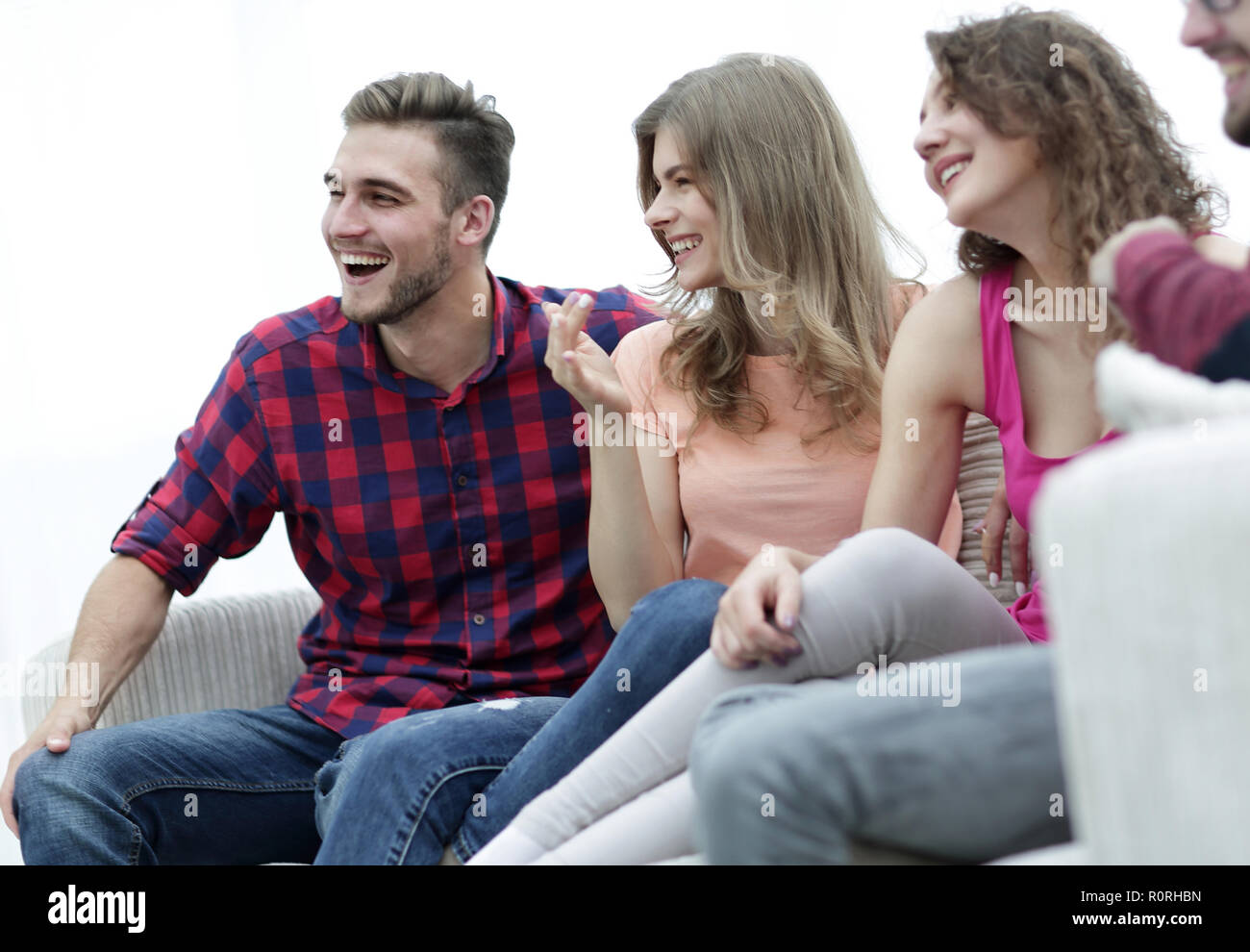 group of cheerful friends sitting on the couch Stock Photo - Alamy