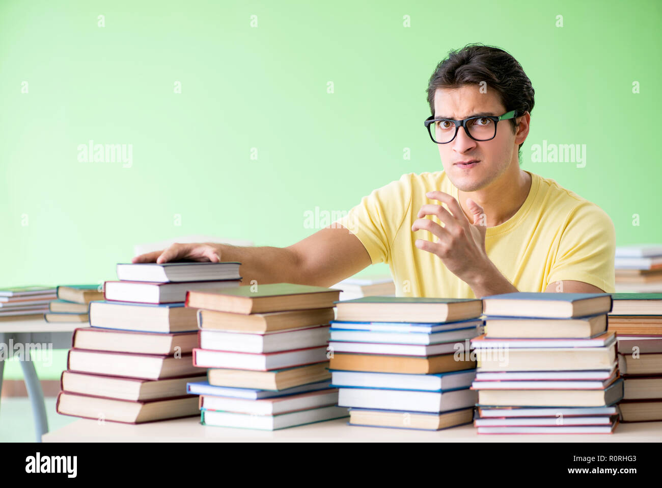 Student with too many books to read before exam Stock Photo - Alamy