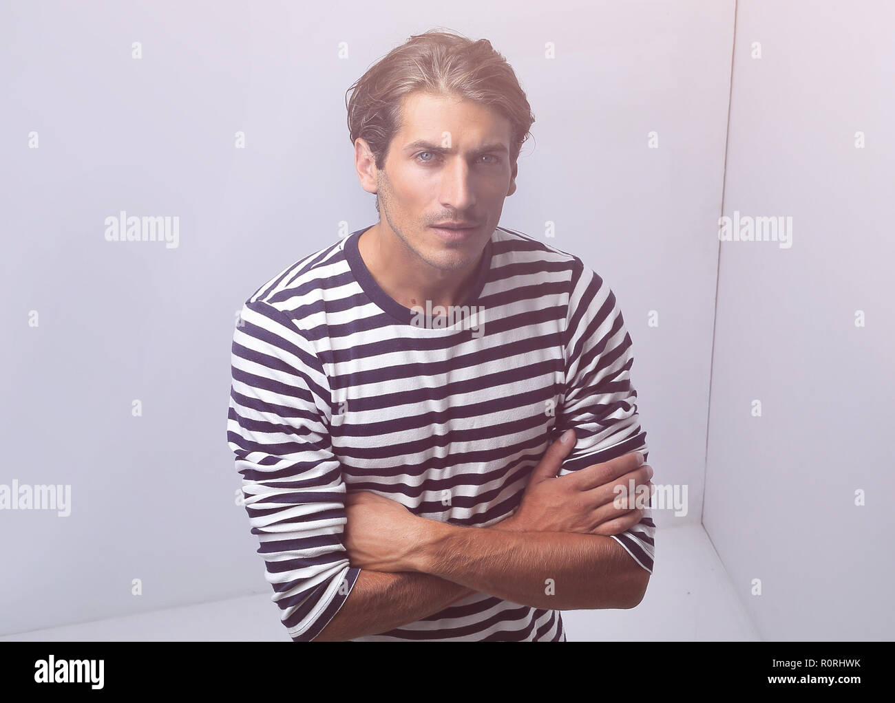 modern man standing in the corner of the white room Stock Photo - Alamy