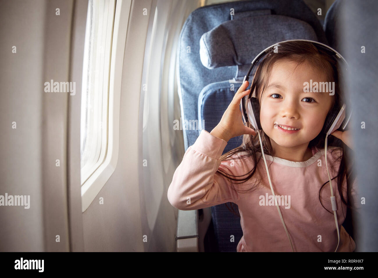 Cute girl on the plane Stock Photo - Alamy